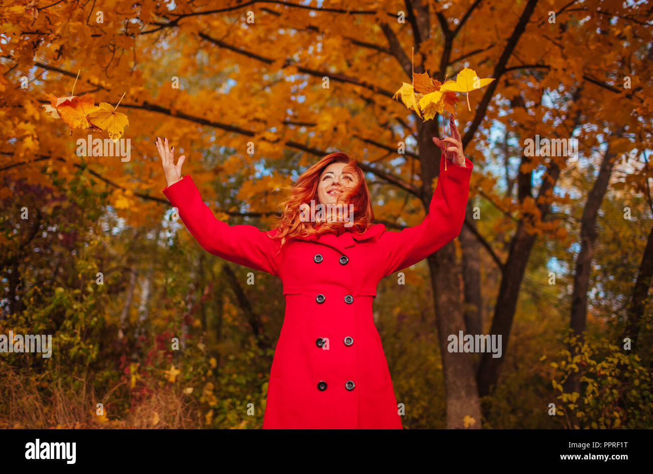 Happy young woman throwing orange hi-res stock photography and images ...