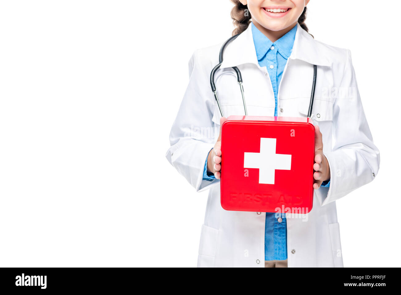 cropped image of schoolchild in costume of doctor holding first aid kit ...