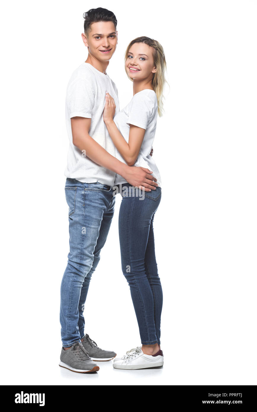 side view of couple hugging and looking at camera isolated on white ...