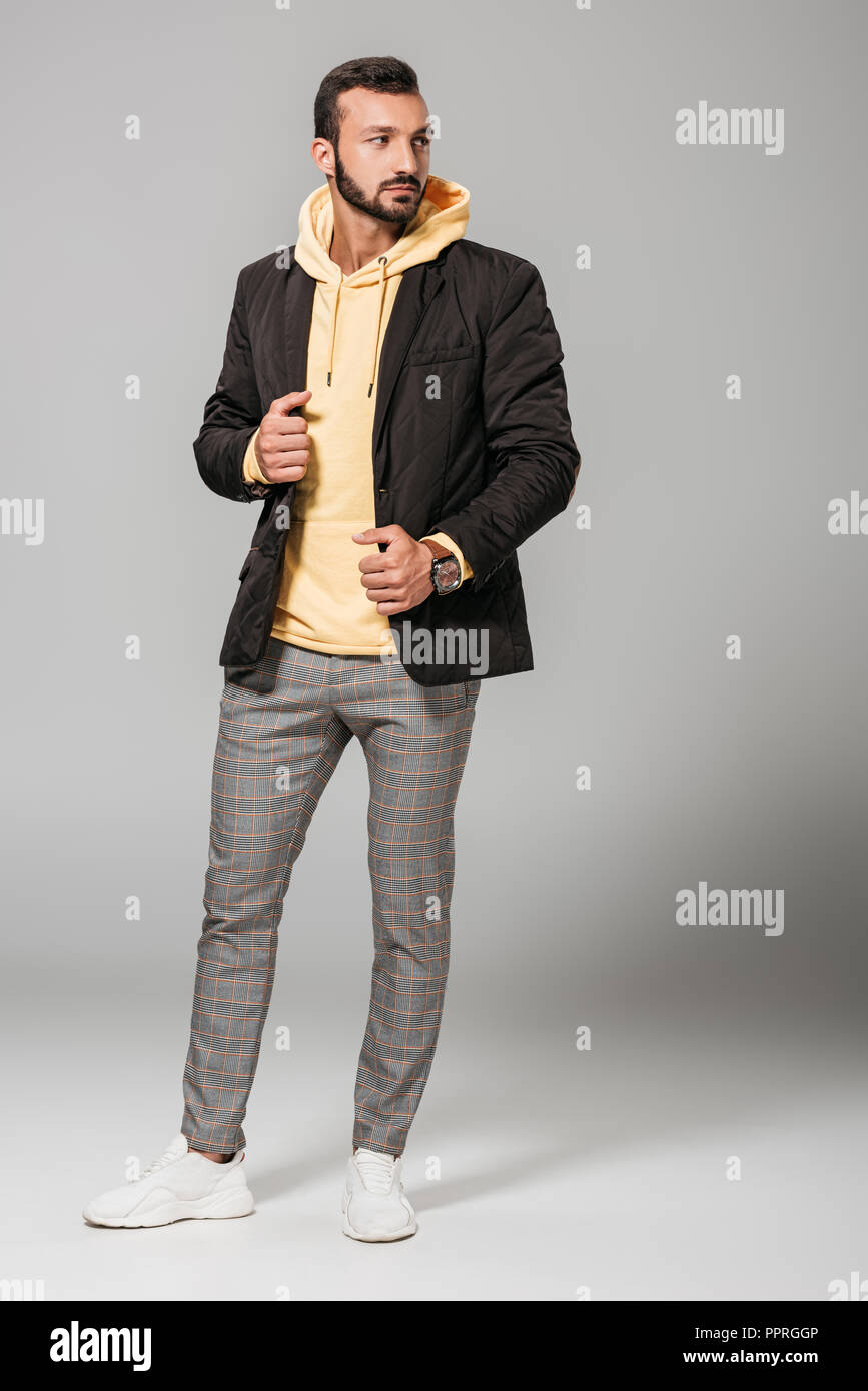 stylish male model in autumn outfit posing on grey background Stock ...