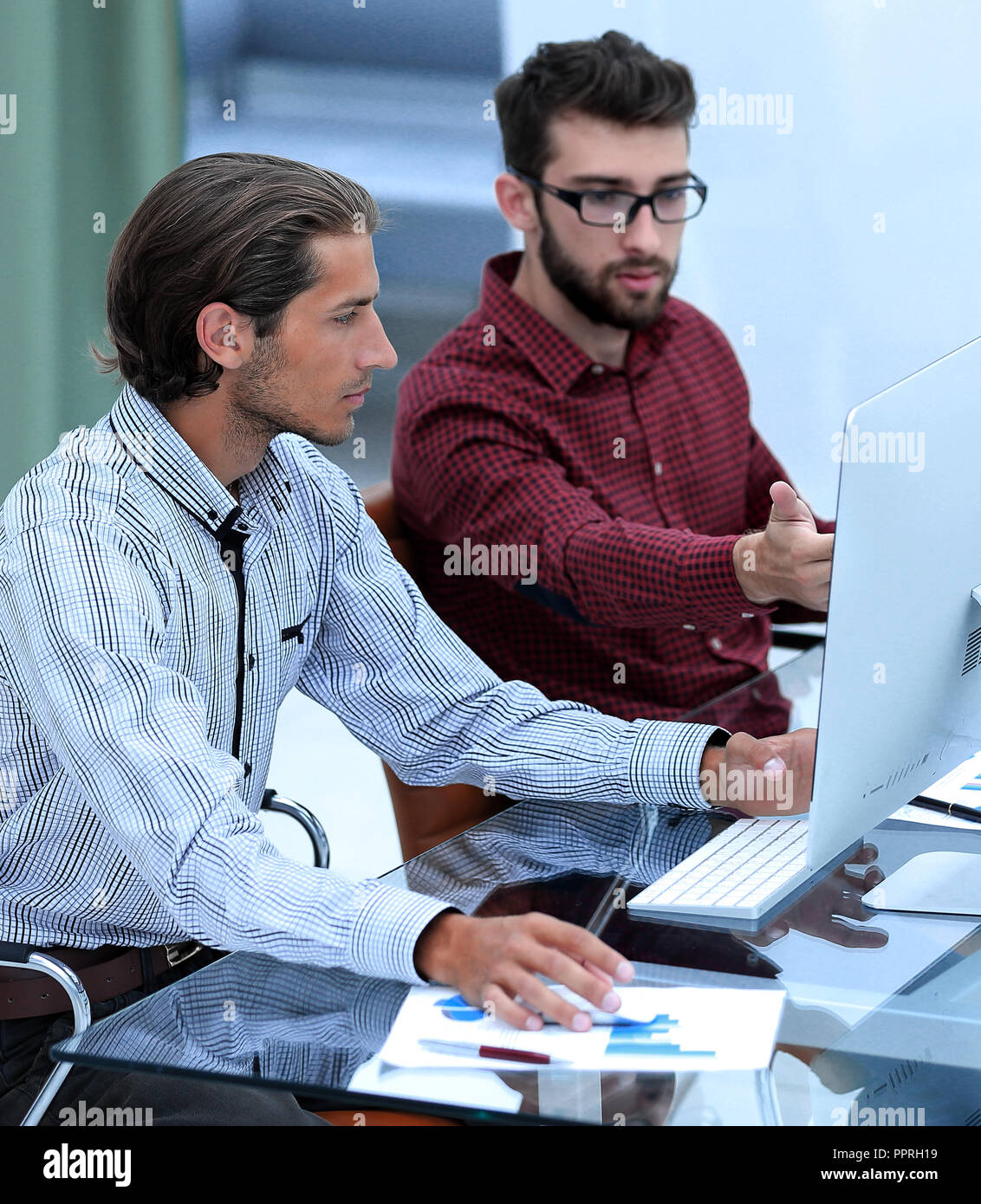 Two employees , sitting in front of computer Stock Photo - Alamy
