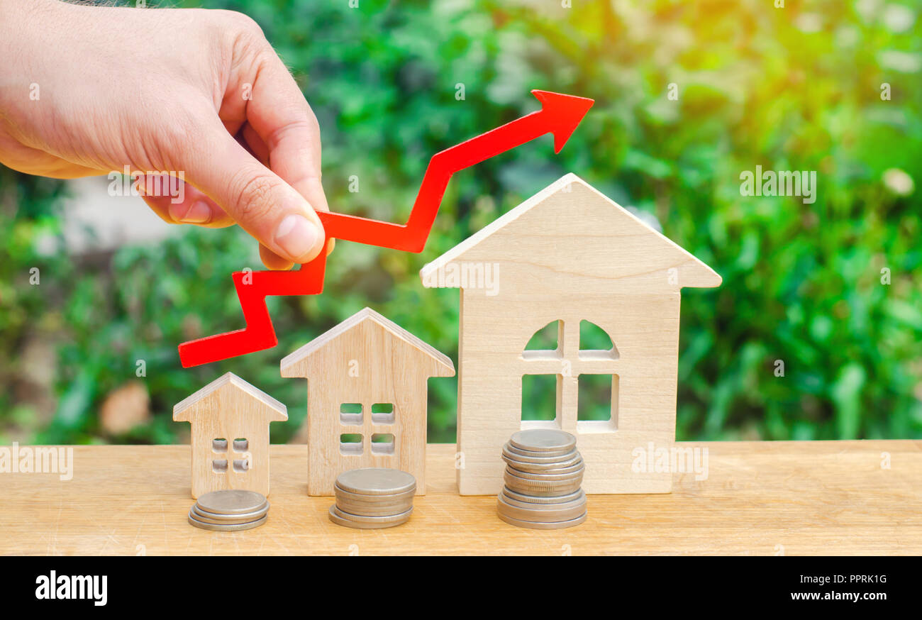 wooden house with a red arrow up. concept of high demand for real ...