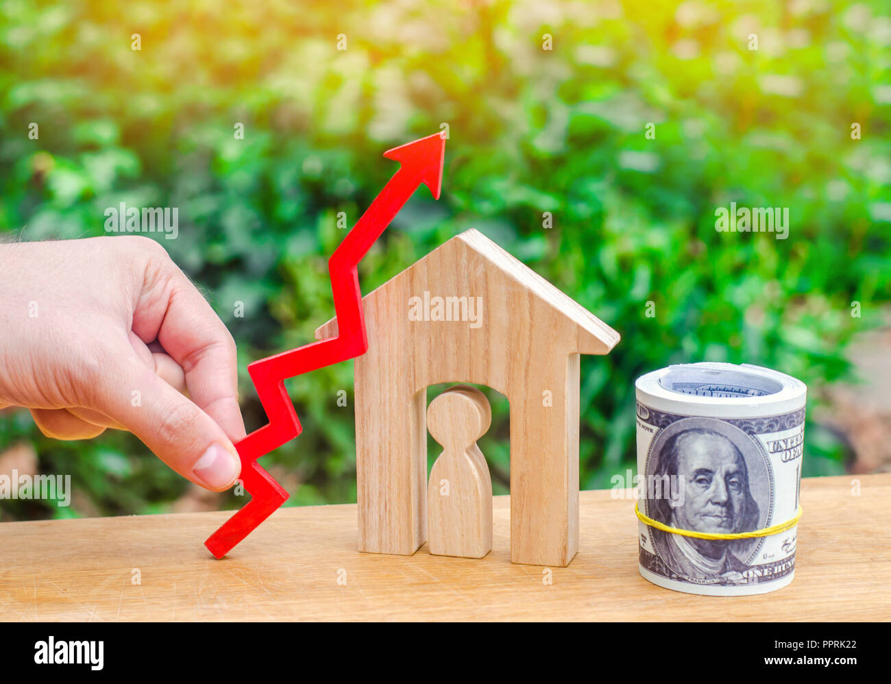 wooden house with a man inside. red arrow up. concept of high demand ...