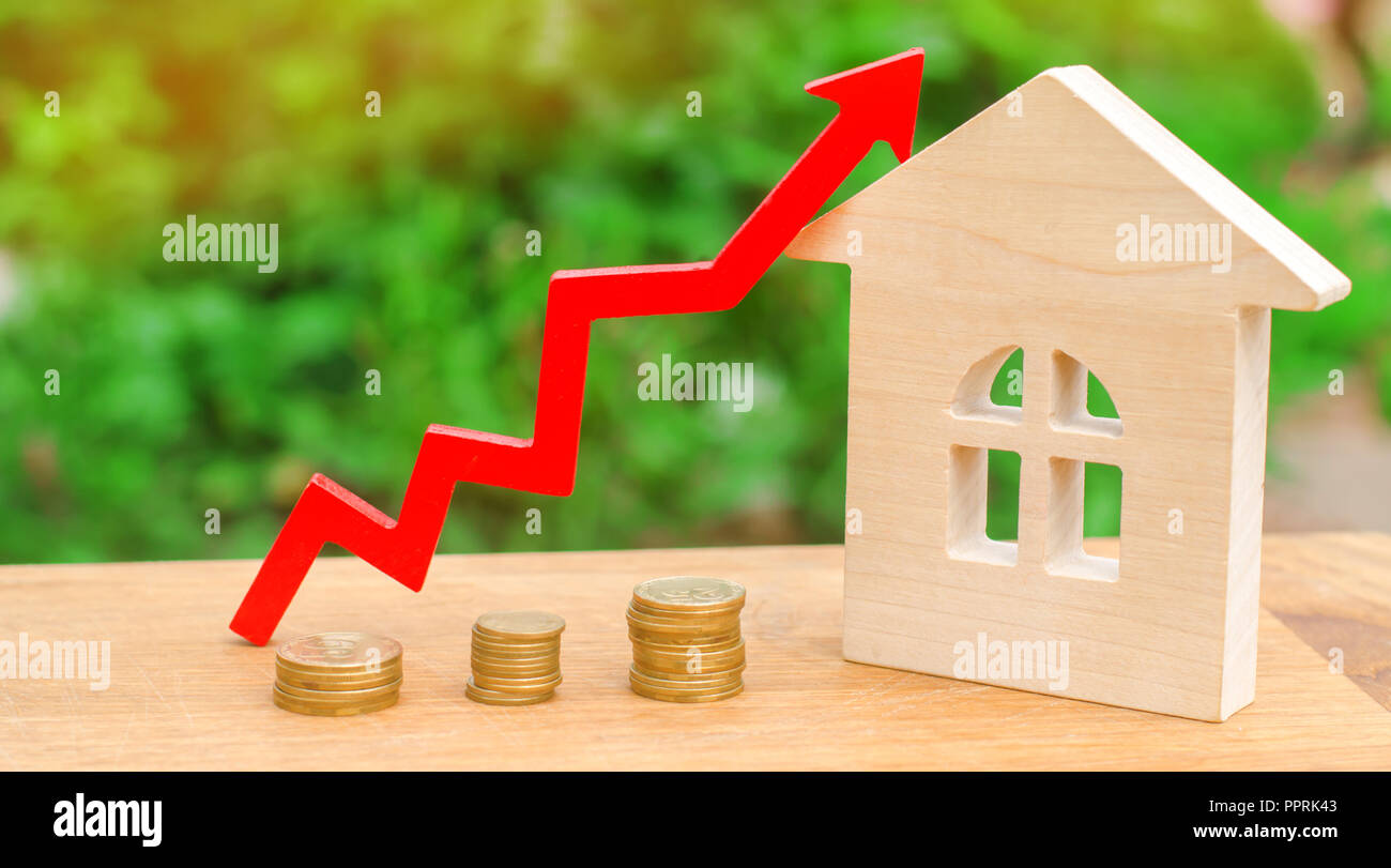 wooden house with a coins and red arrow up. concept of high demand for ...
