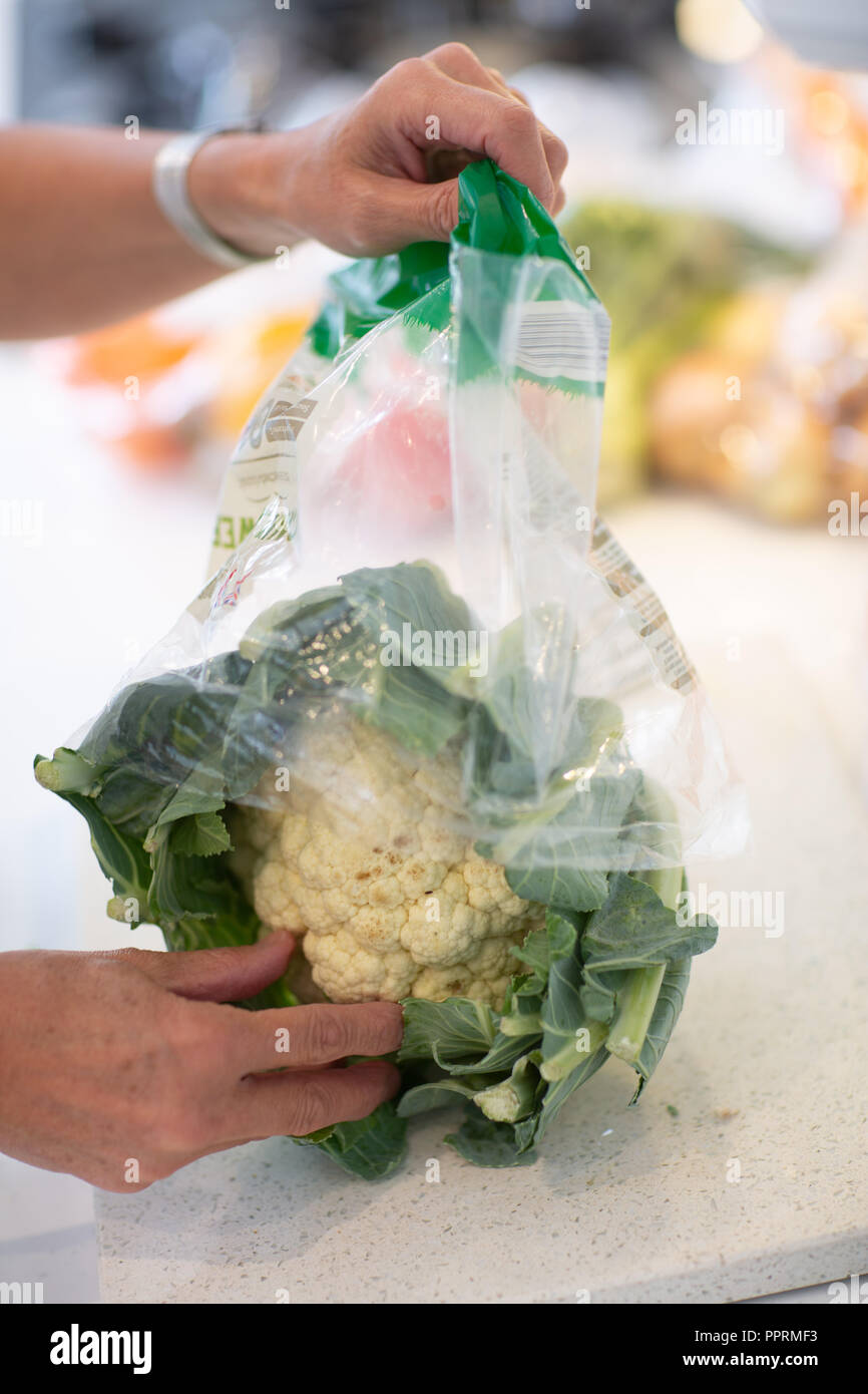 Unpacking plastic wrapped fruit and vegetables in the kitchen - Plastic ...