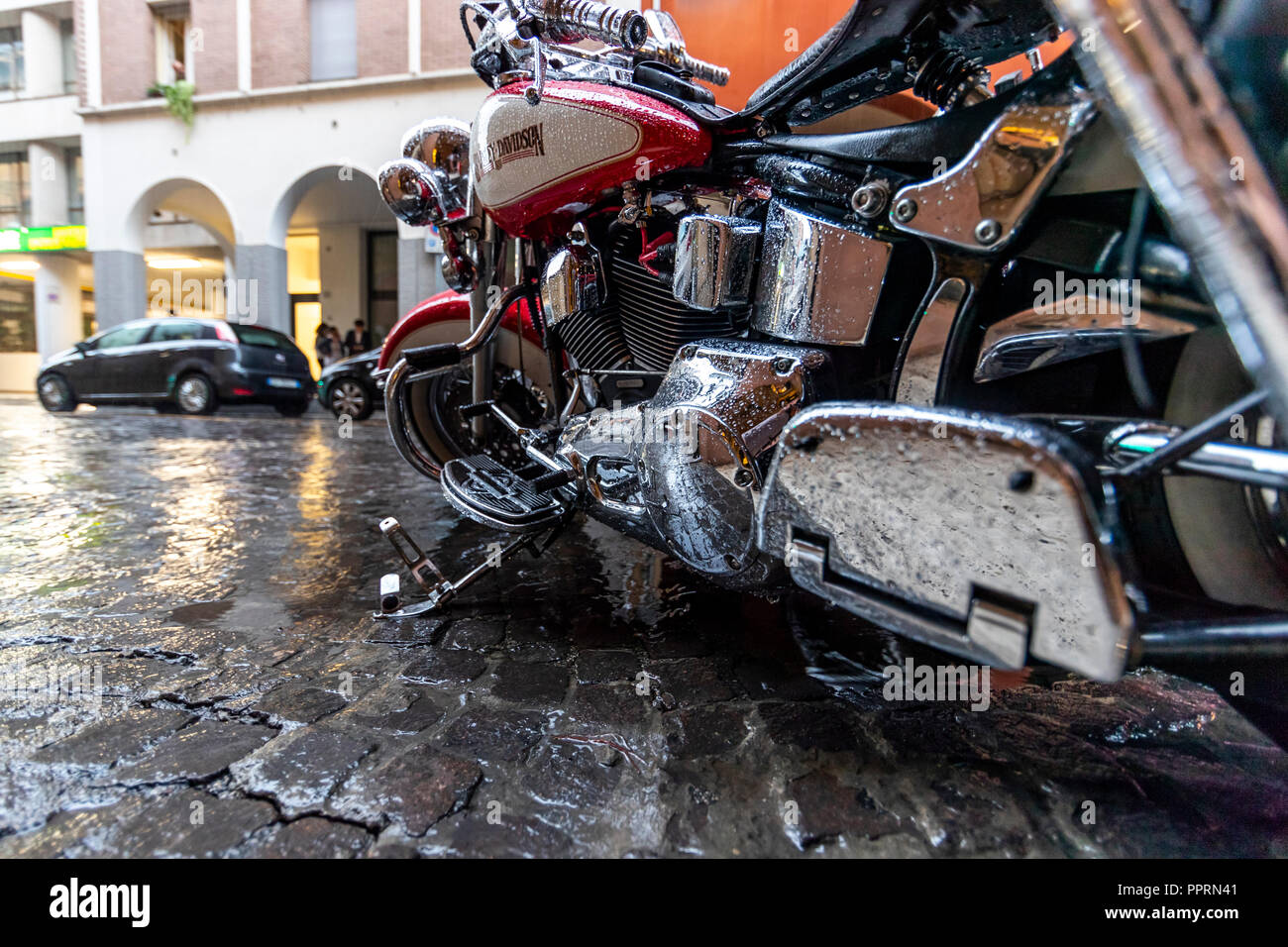 Harley Davidson motorcycle parked in the rain outside Il Santo Bevitore ...