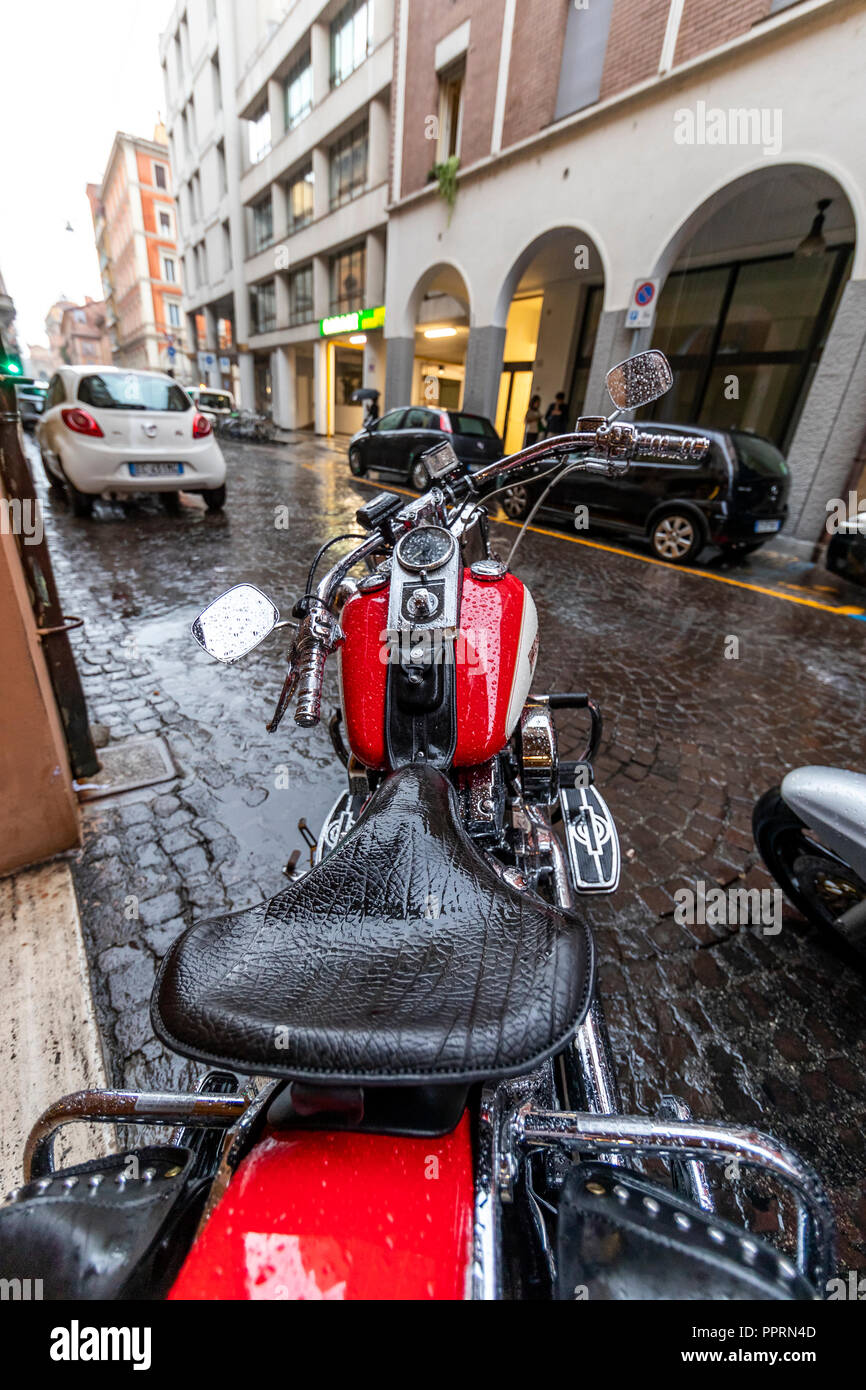 Harley Davidson motorcycle parked in the rain outside Il Santo Bevitore ...