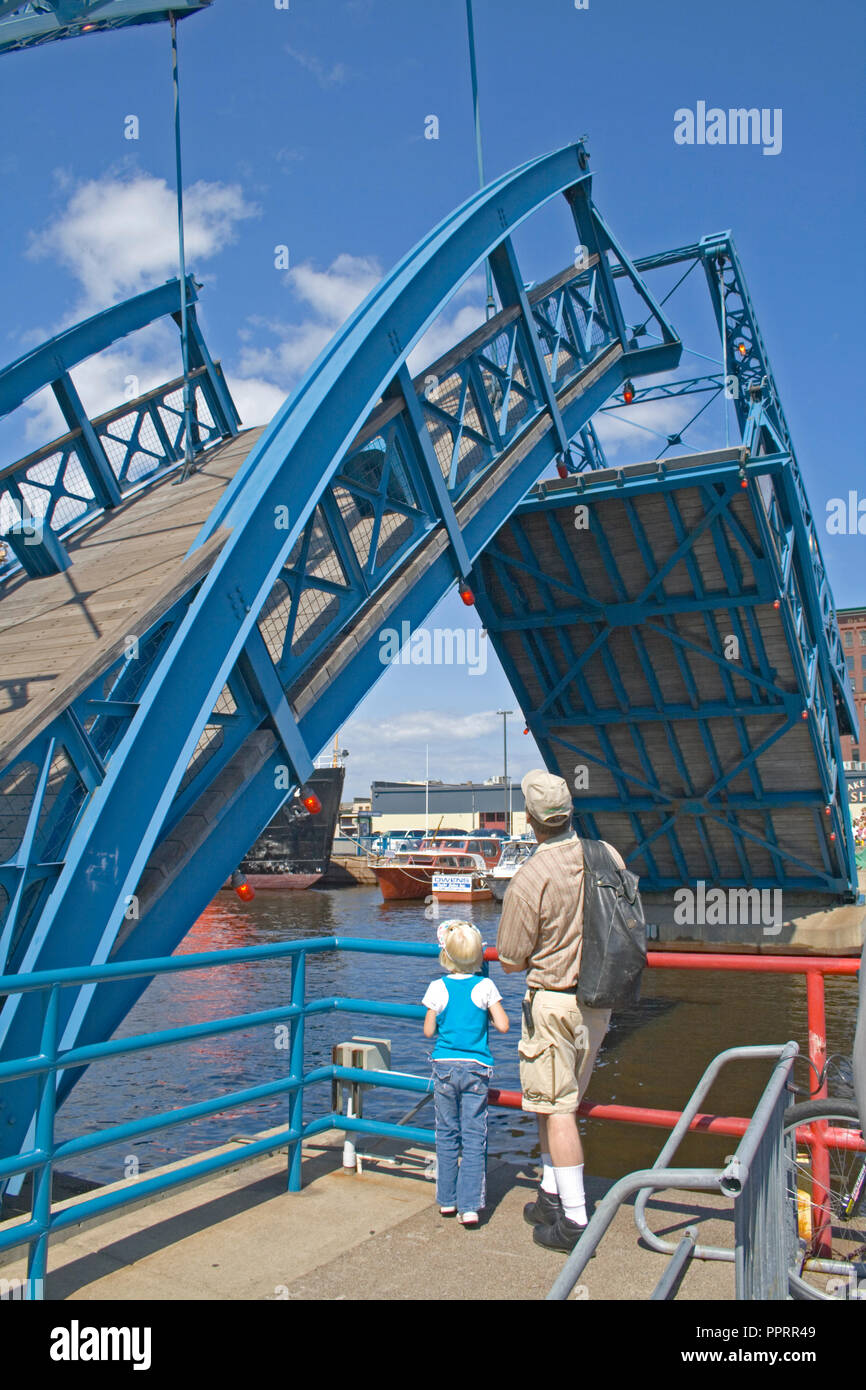 Father and daughter viewing The Minnesota Slip Drawbridge located in ...