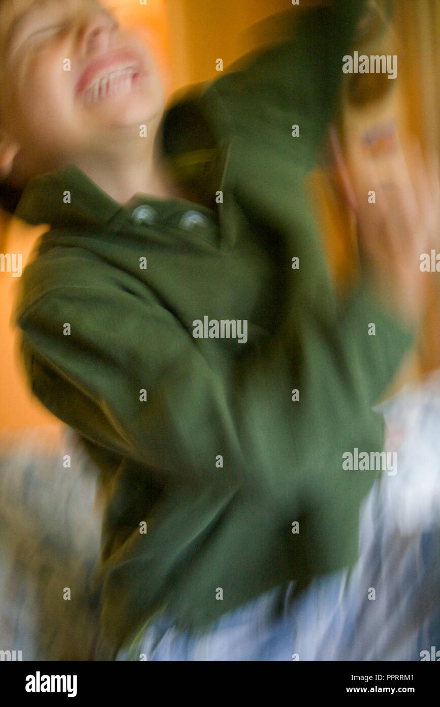 Boy age six happily twirling around at the family home. Battle Lake ...