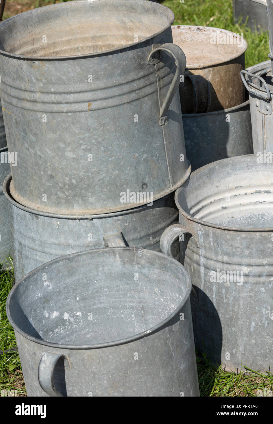a collection of traditional galvanised steel garden containers and tubs ...