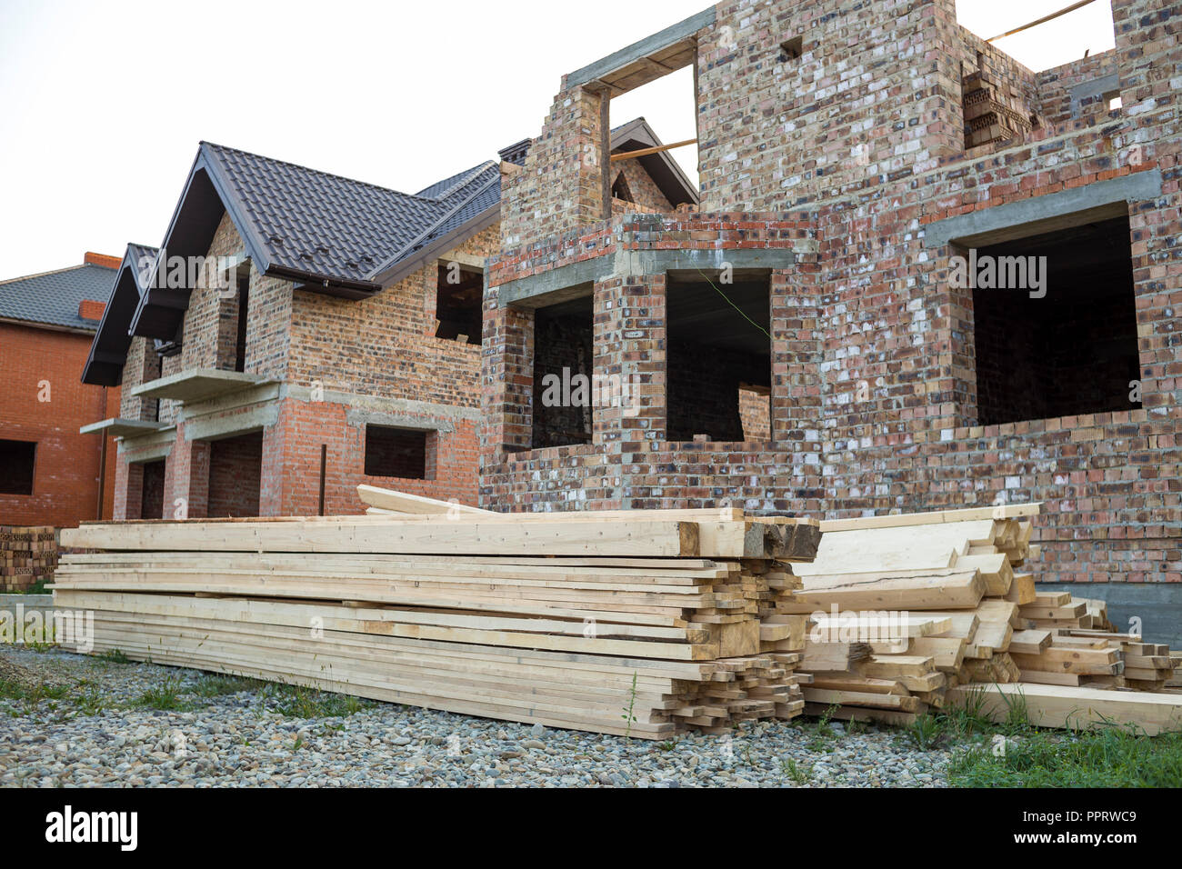 Future cottage under construction and pile of gravel and stack of ...