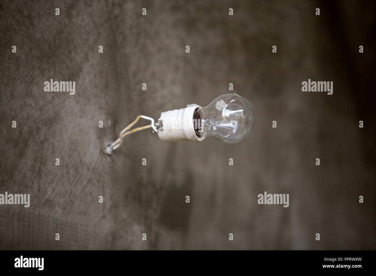 Close up of isolated dirty simple electric light bulb with broken ...