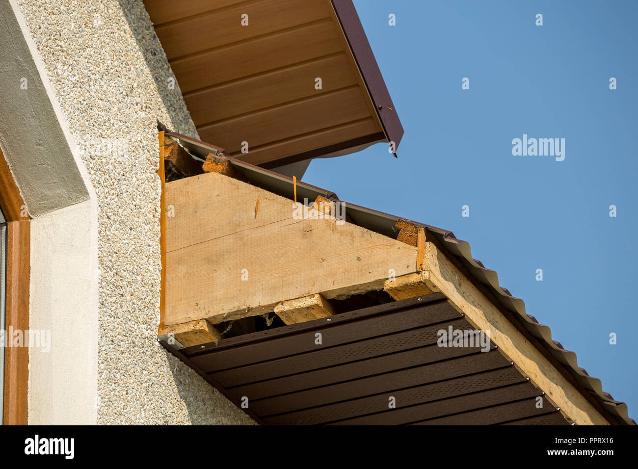 Bottom view detail of new modern house cottage corner with stucco walls ...