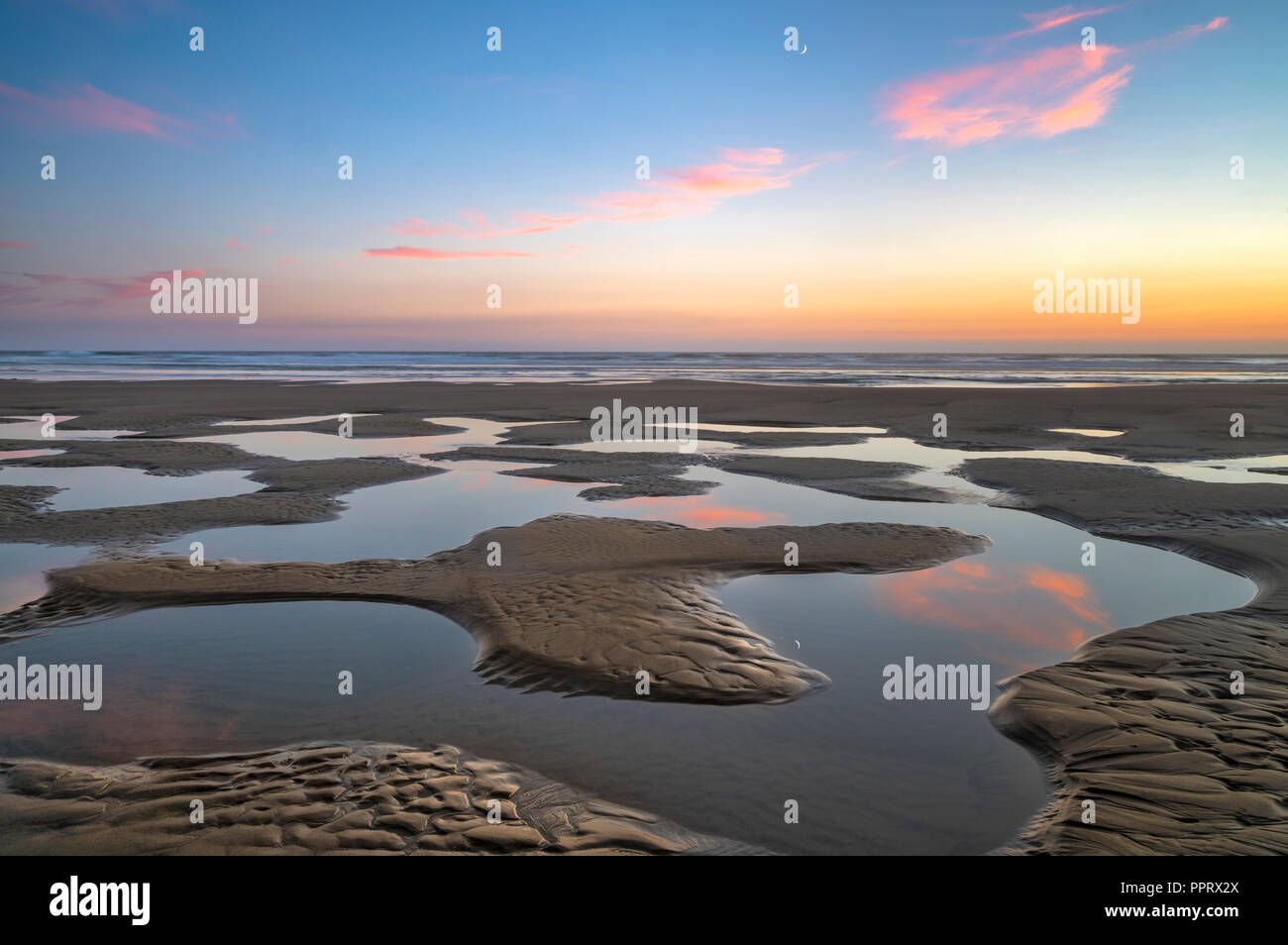 Manzanita, Oregon: Tide pools reflecting sunset sky, Manzanita beach ...