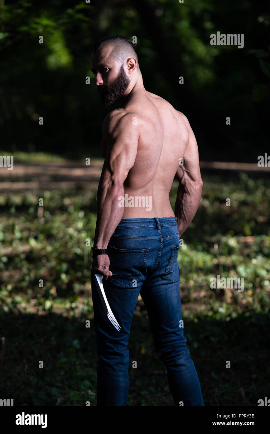 Wolverine With Claws Standing Strong Outdoors and Flexing Muscles ...