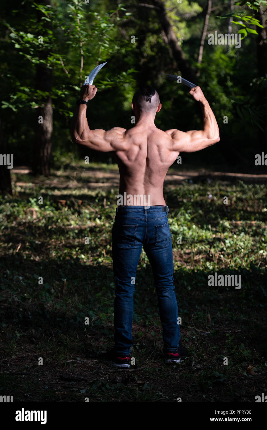 Wolverine With Claws Standing Strong Outdoors and Flexing Muscles ...