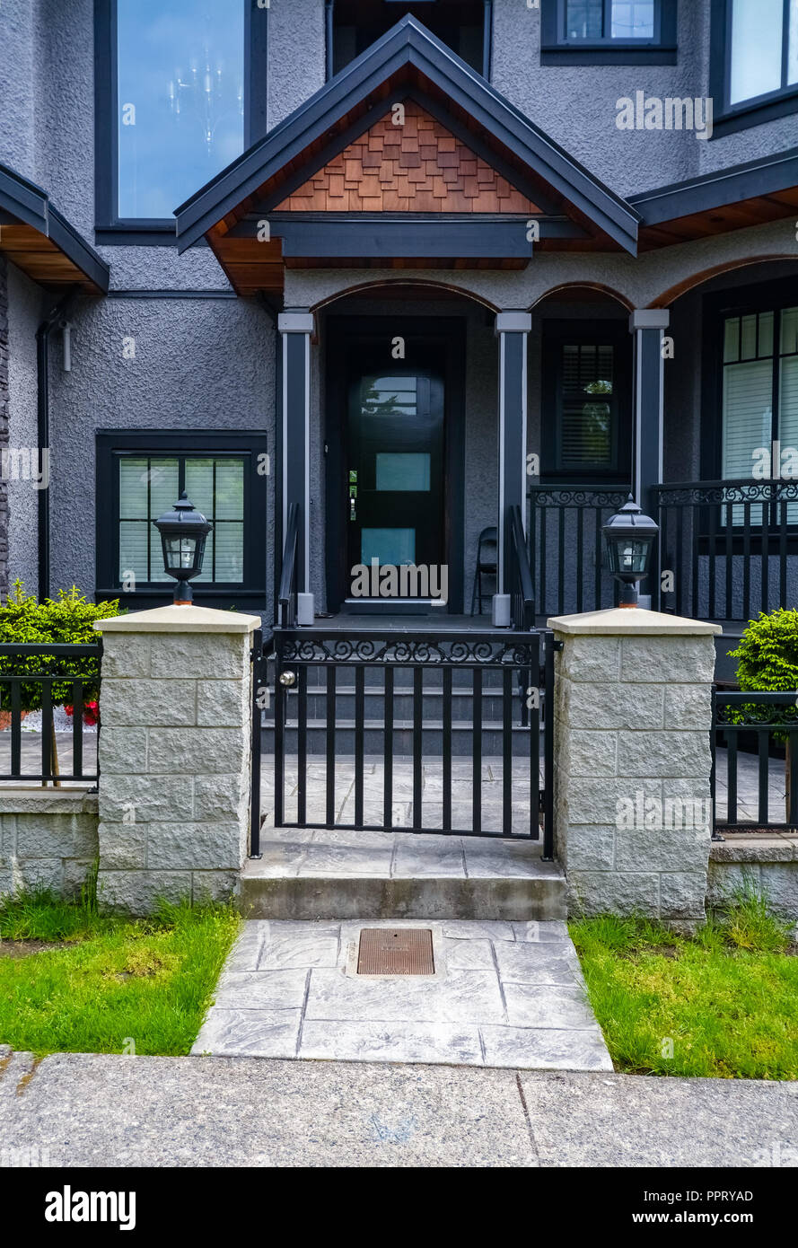 Entrance of residential house with metal grid gate in front. Dark ...