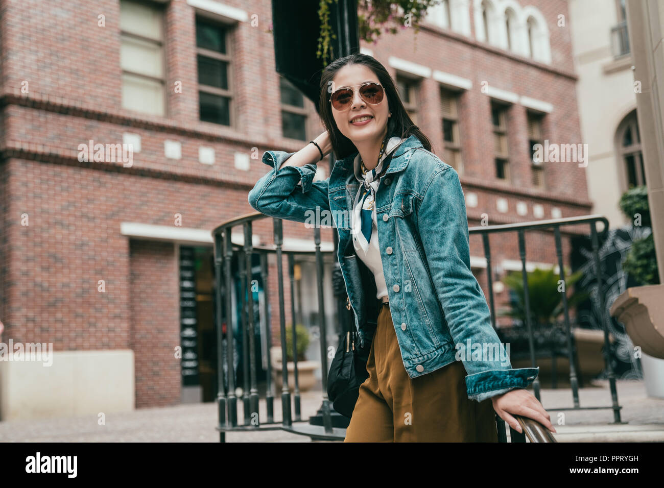 young confident lady giving an attractive smile to the camera while she ...