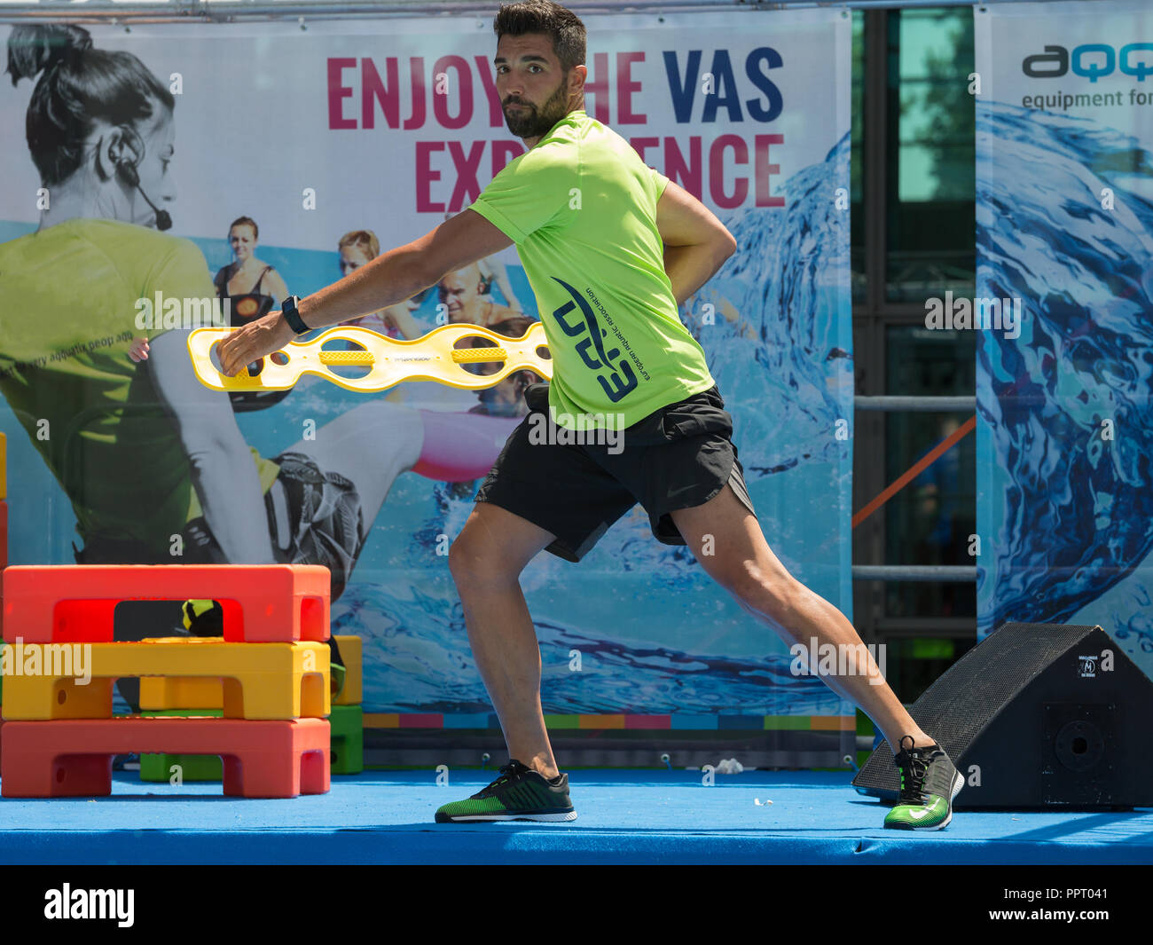 Instructor in Outdoor Fitness Class teaching Exercises on Stage Stock ...
