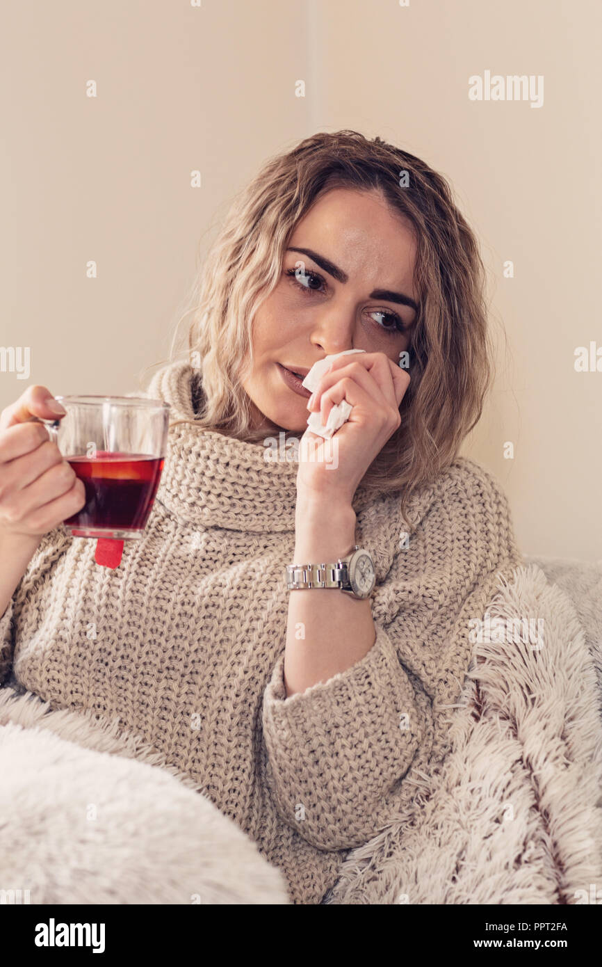 Young beautiful sick woman feeling ill and bad lying on bed suffering ...