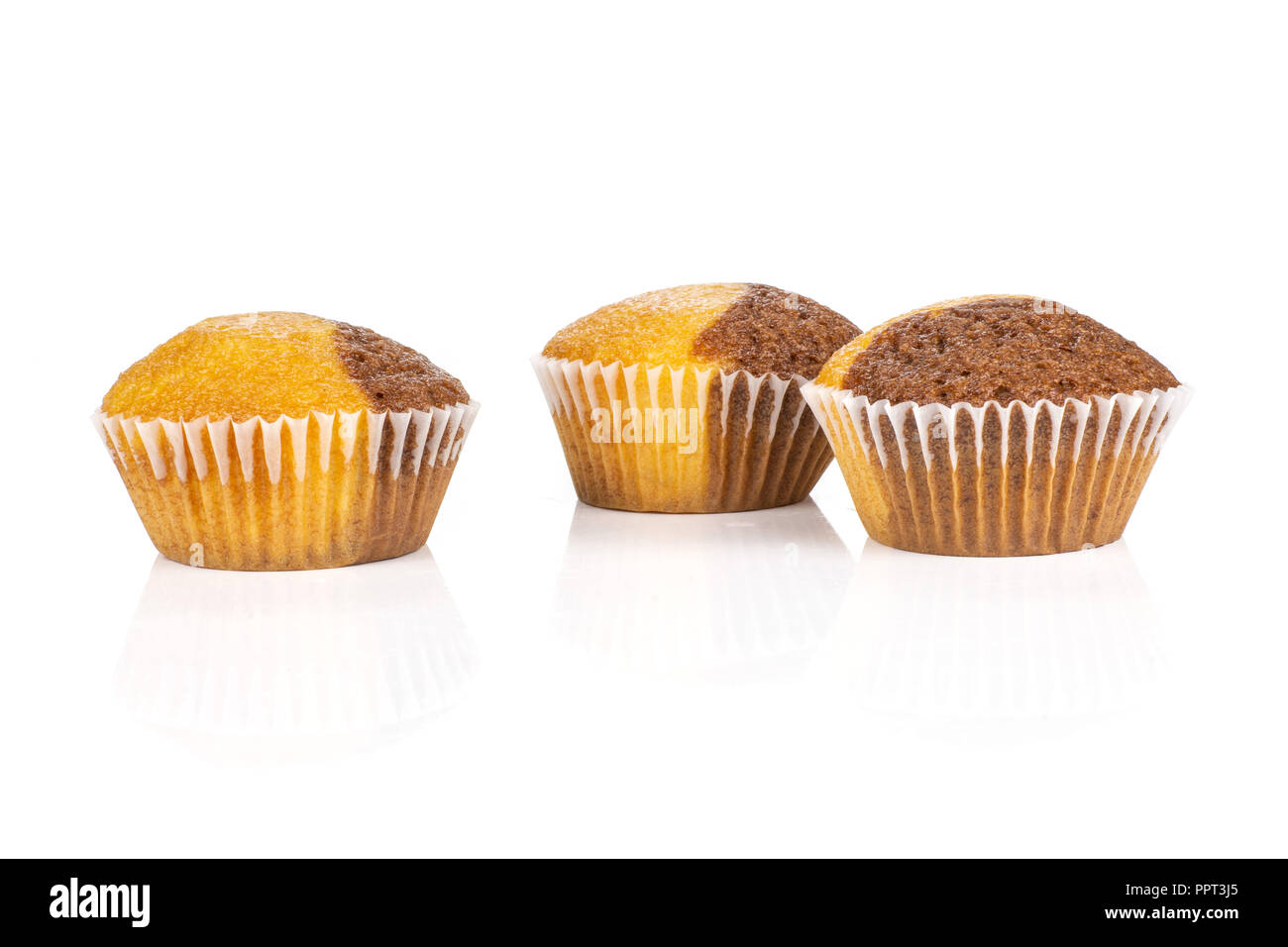 Group of three whole fresh baked marble muffin isolated on white ...