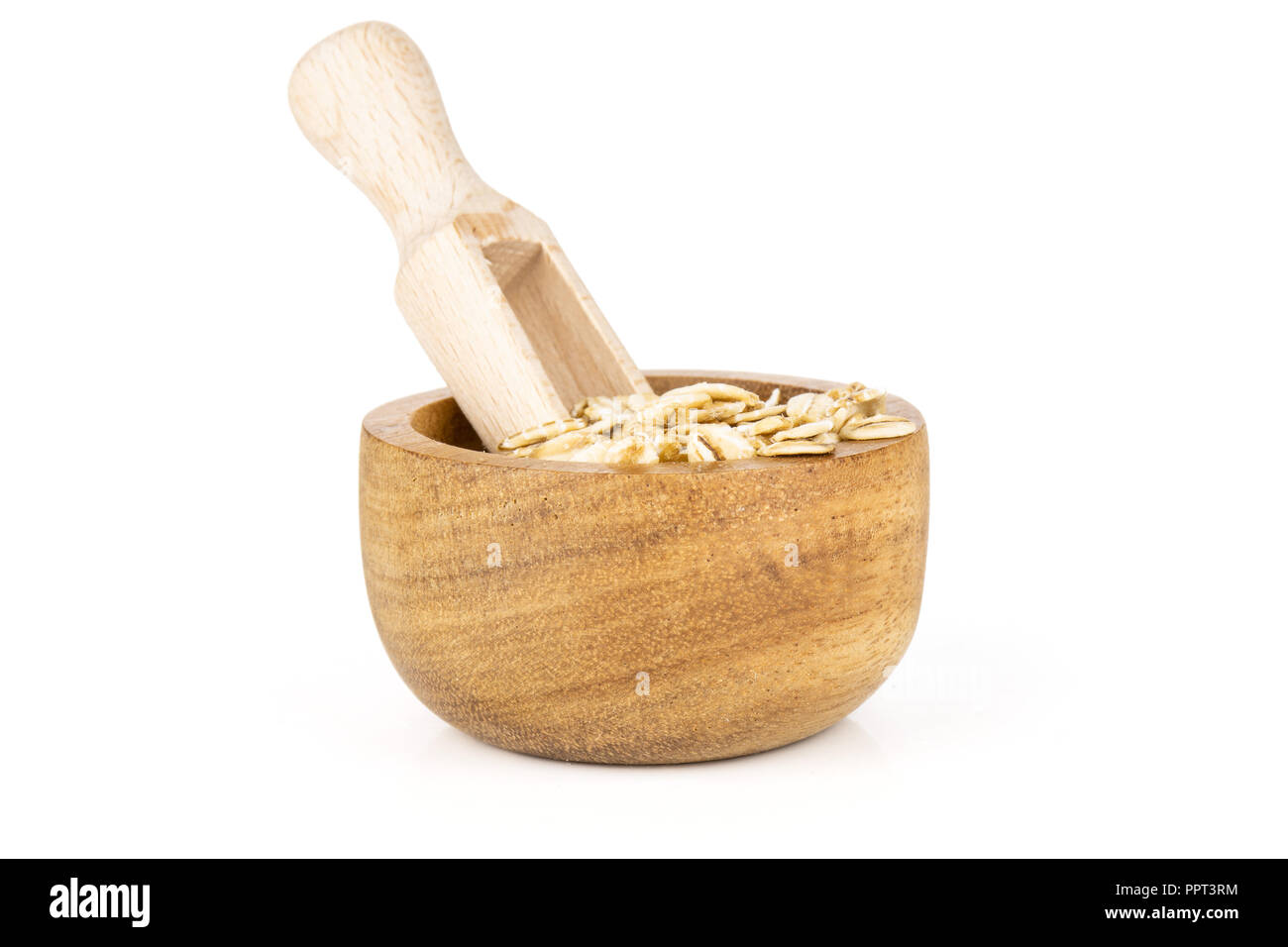Lot of whole flat raw rolled oats and a scoop with wooden bowl isolated ...