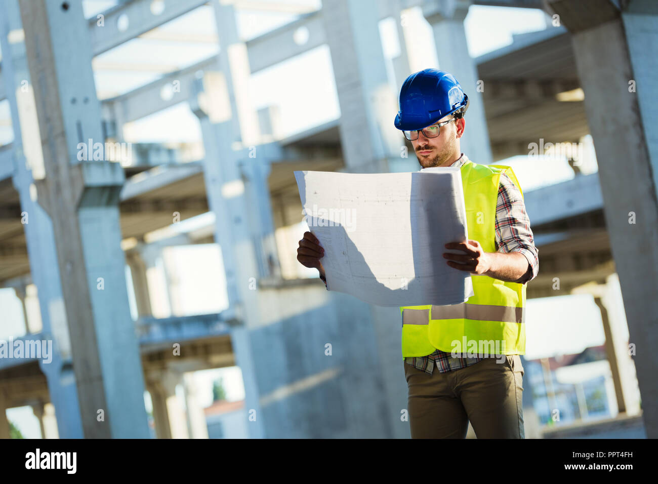 Picture of construction site engineer looking at plan Stock Photo - Alamy