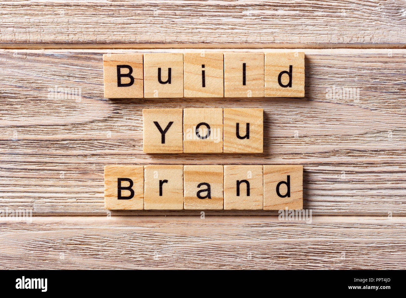 BUILD YOUR BRAND word written on wood block. BUILD YOUR BRAND text on ...