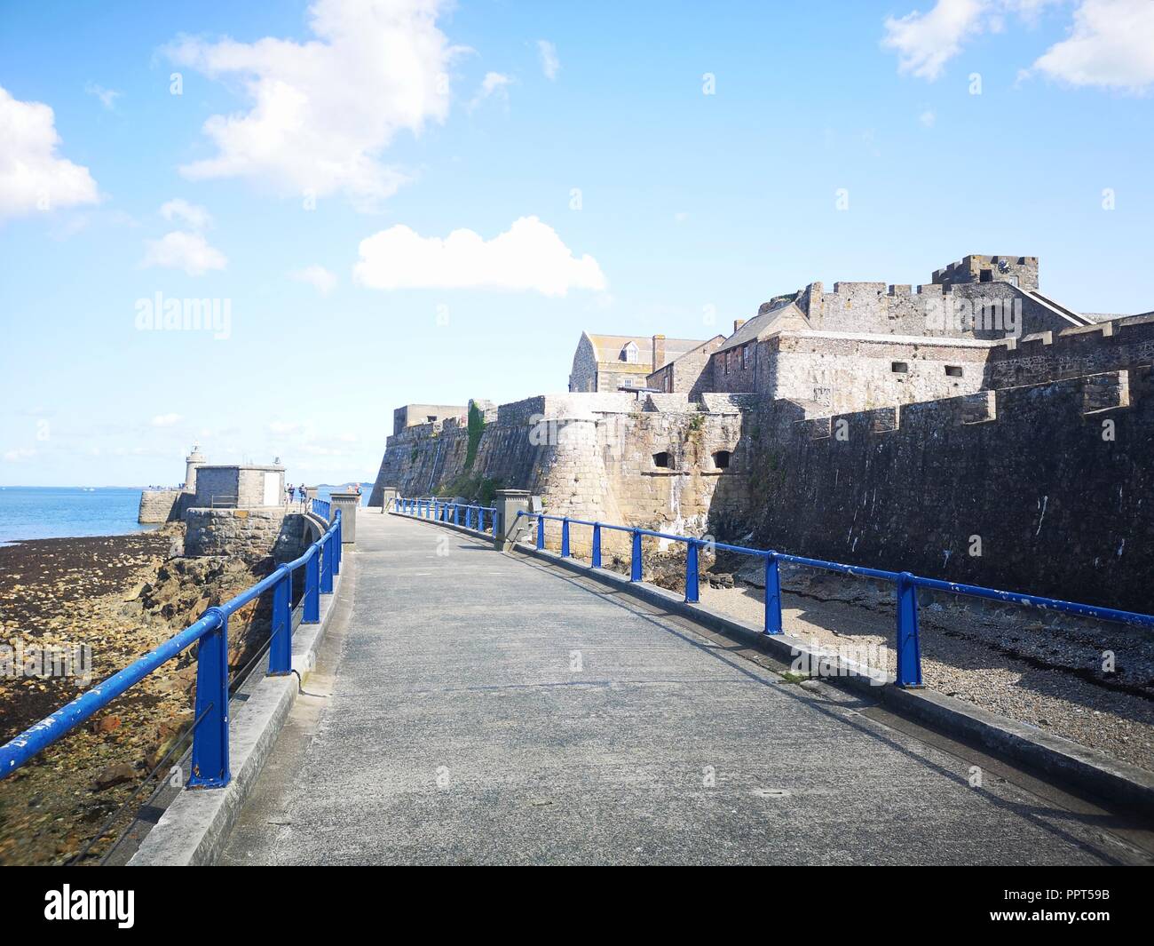 St Peter Port, Guernsey, UK: August 25, 2018: Tourists walk along the ...