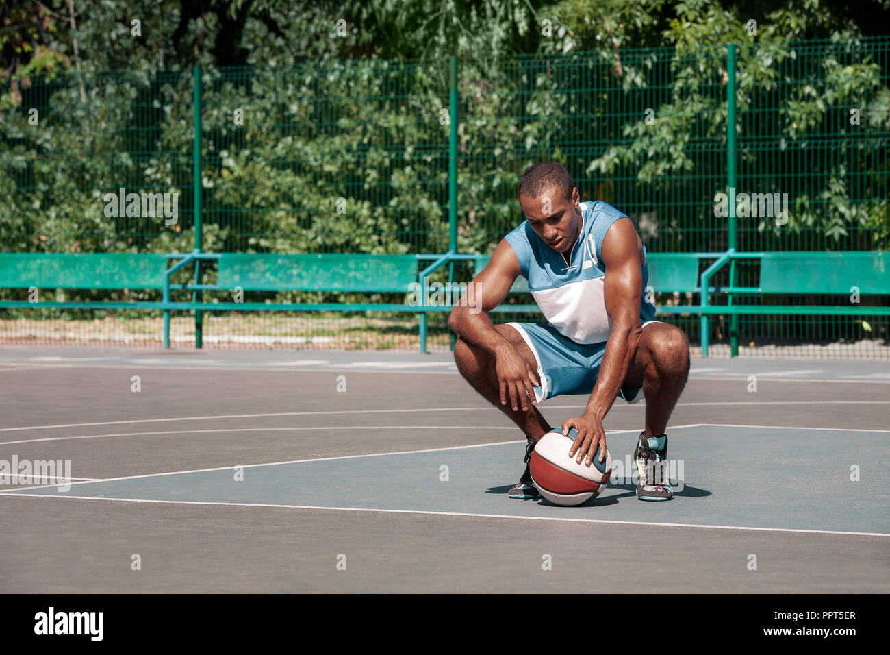 Picture of young confused african basketball player practicing outdoor ...