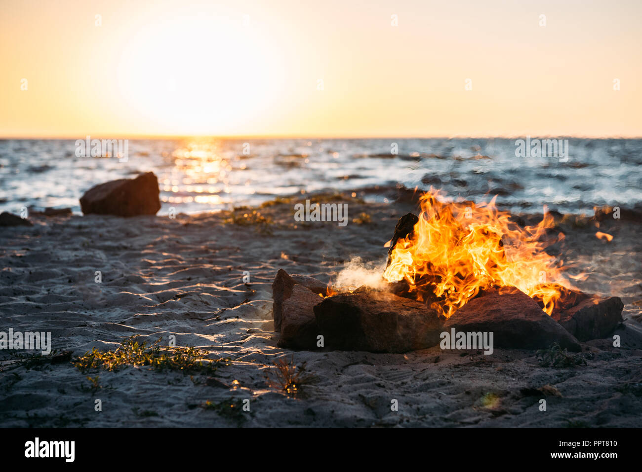 Sunset bonfire on the beach hi-res stock photography and images - Alamy