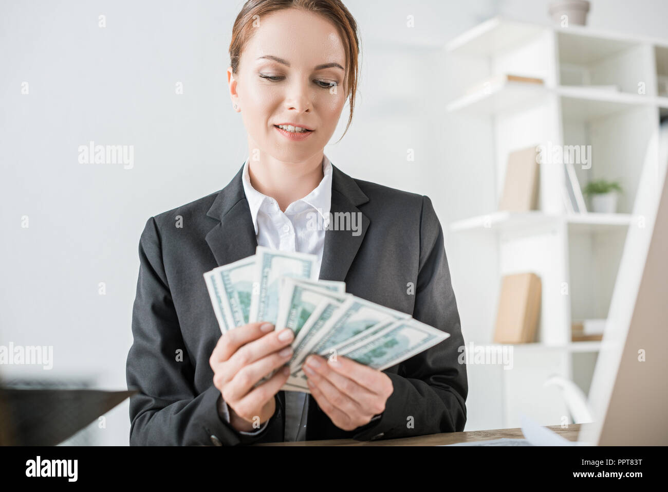 smiling financier counting cash in office Stock Photo - Alamy