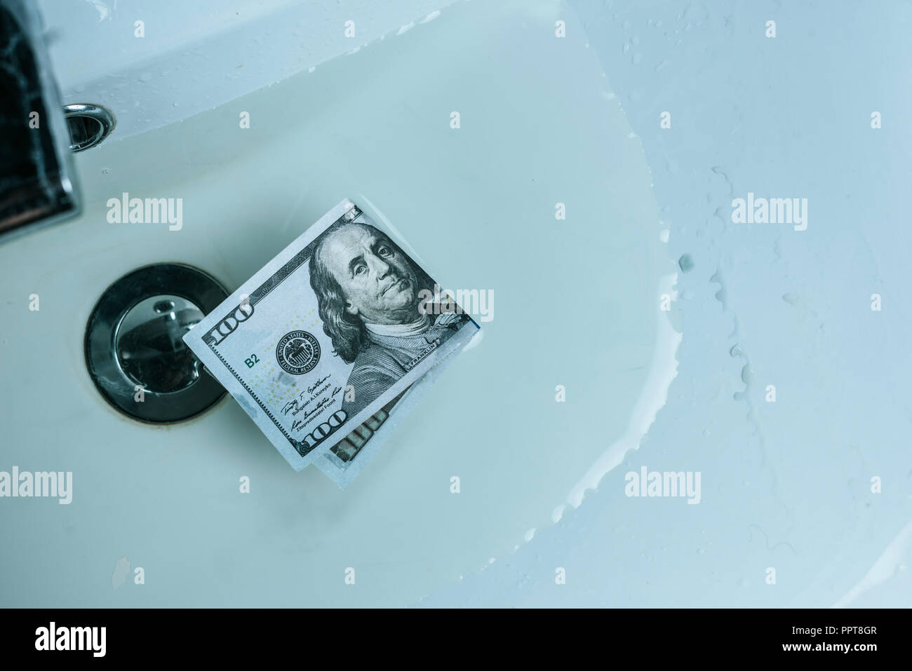 top view of dollar banknote in water in sink Stock Photo - Alamy