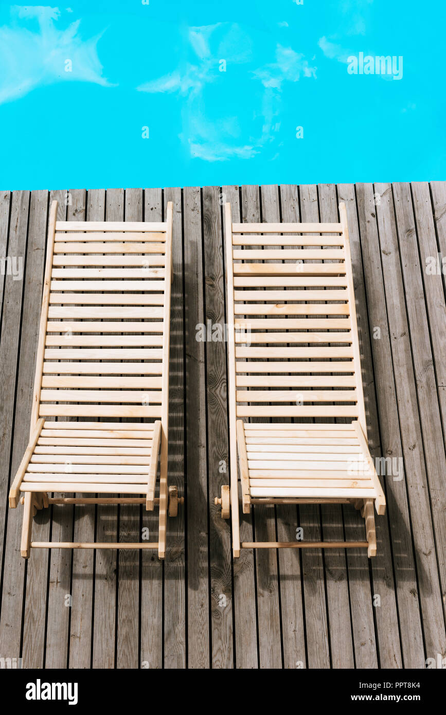 high angle view of empty chaise lounges near swimming pool Stock Photo ...