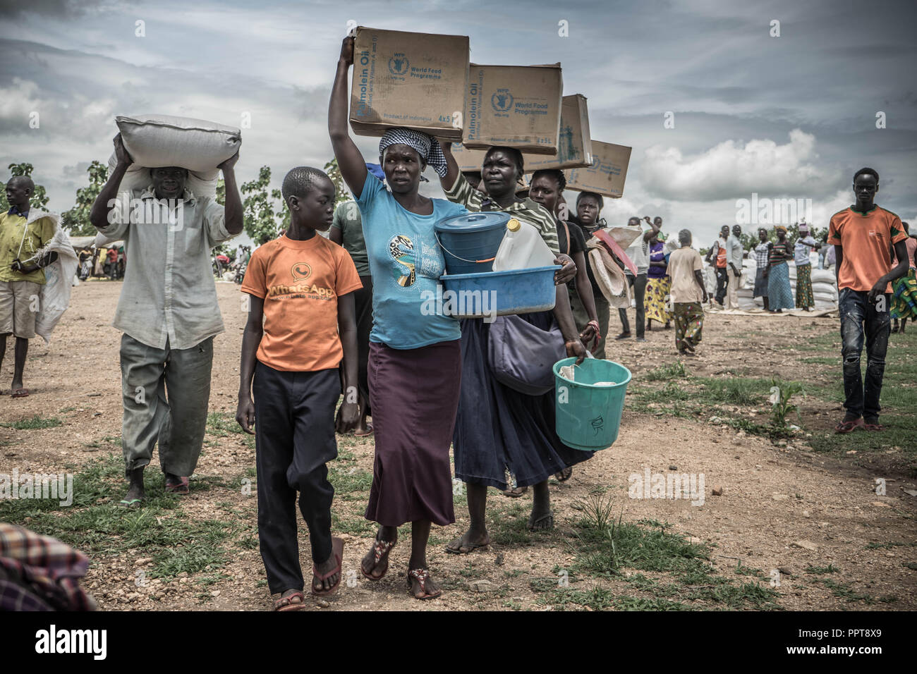South Sudanese Female Refugees Seen Carrying Palm Oil On Top Of Their