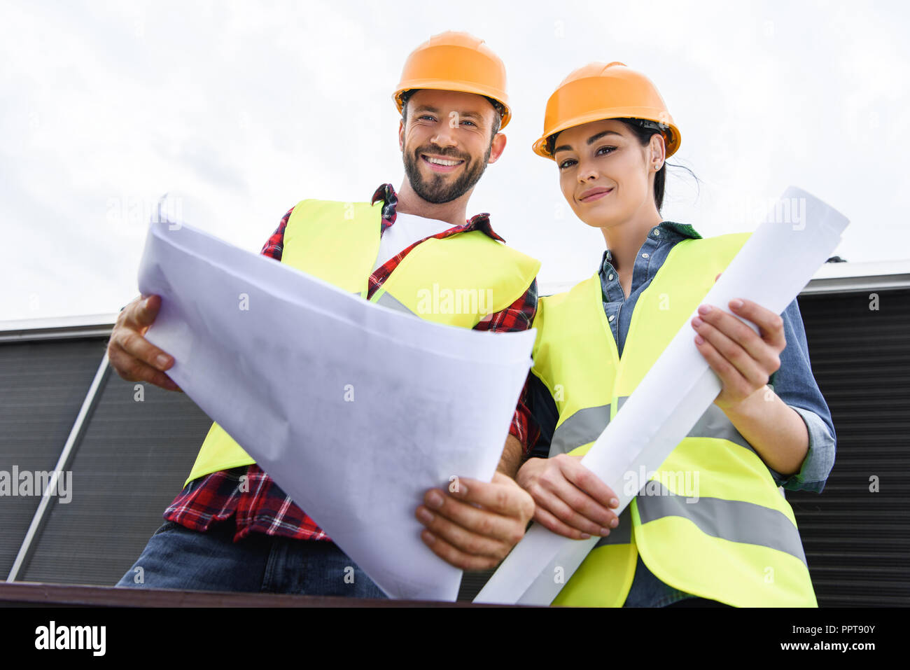 bottom view of architects in hardhats working with blueprints Stock ...