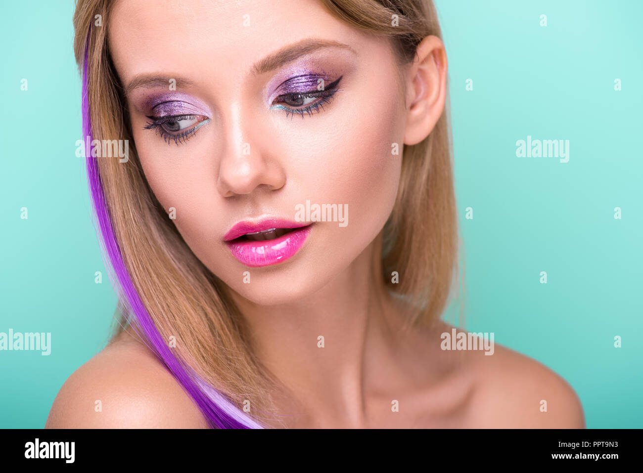 Close Up Portrait Of Beautiful Young Woman With Stylish Makeup And Purple Hair Strand Isolated