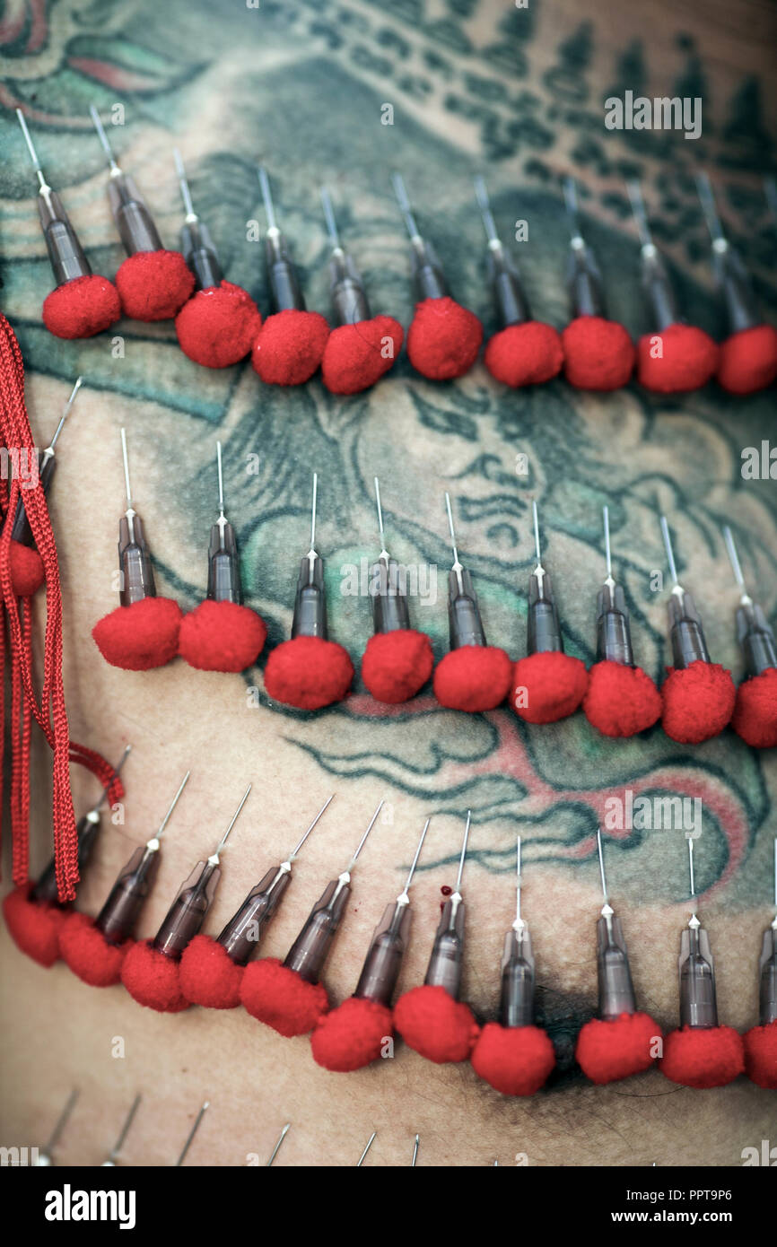 Man having chest pierced dozens of times at Phuket Vegetarian Festival ...