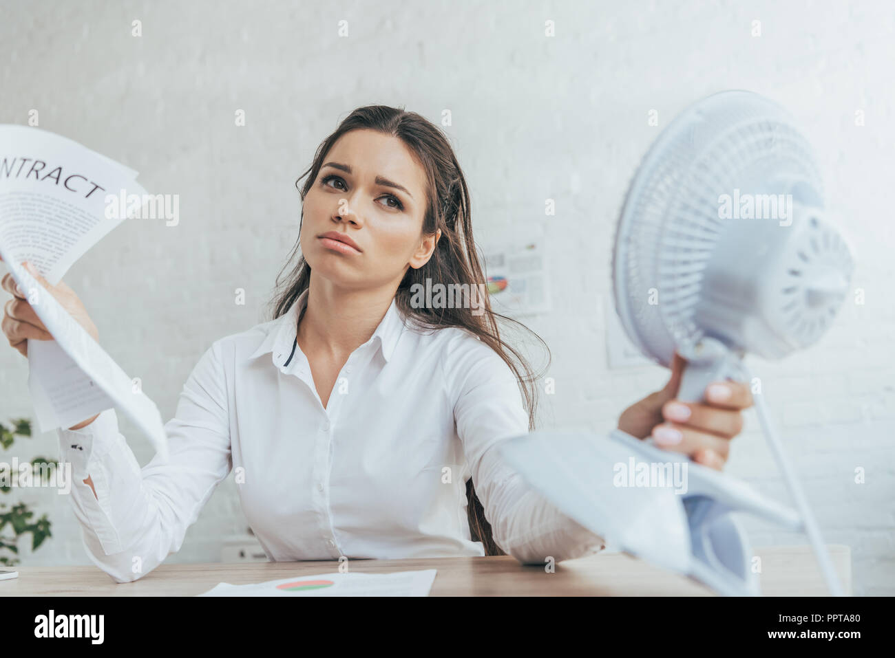 Electric fan person cooling hi-res stock photography and images - Alamy