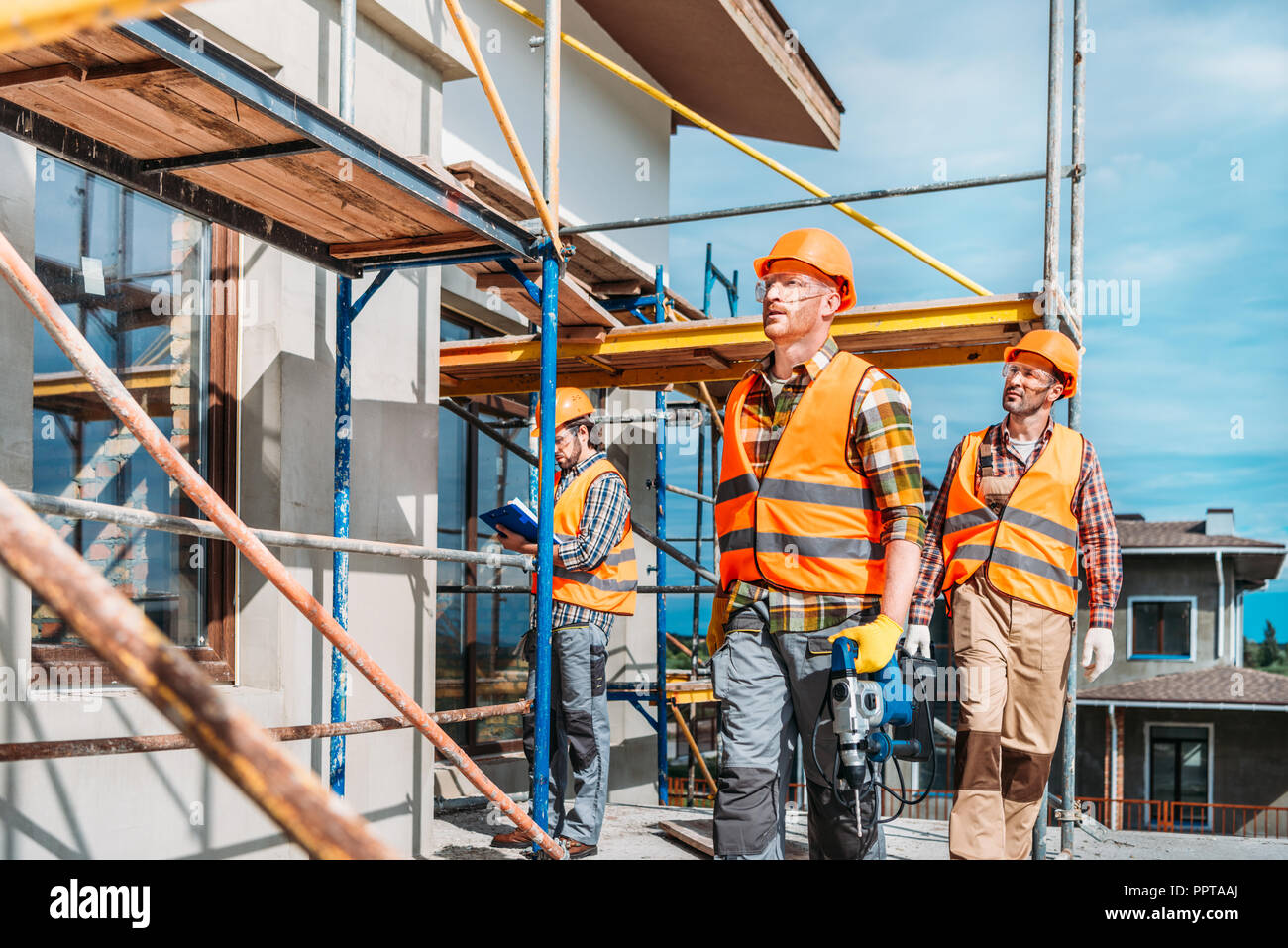 group of handsome builders working together at construction site Stock ...