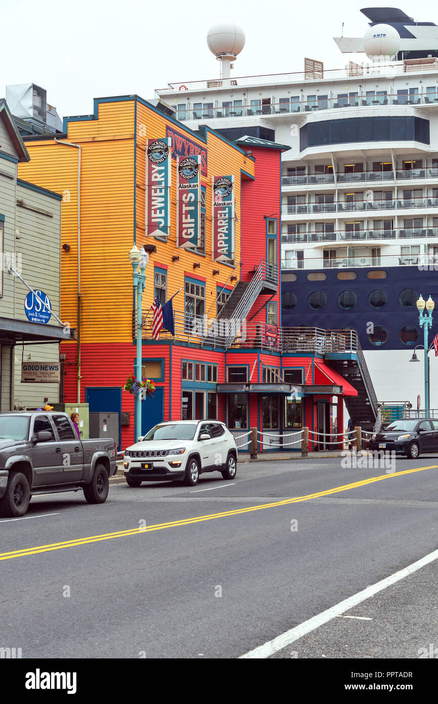 Colorful store building and giant cruise ship on the pier, Ketchikan ...
