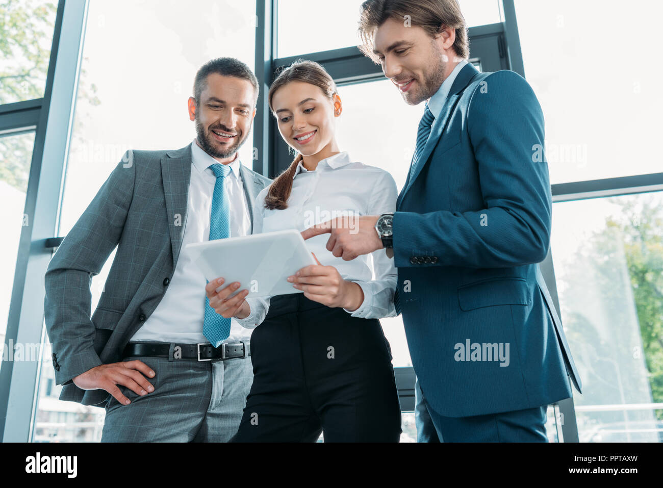 Business people using tablet together hi-res stock photography and ...