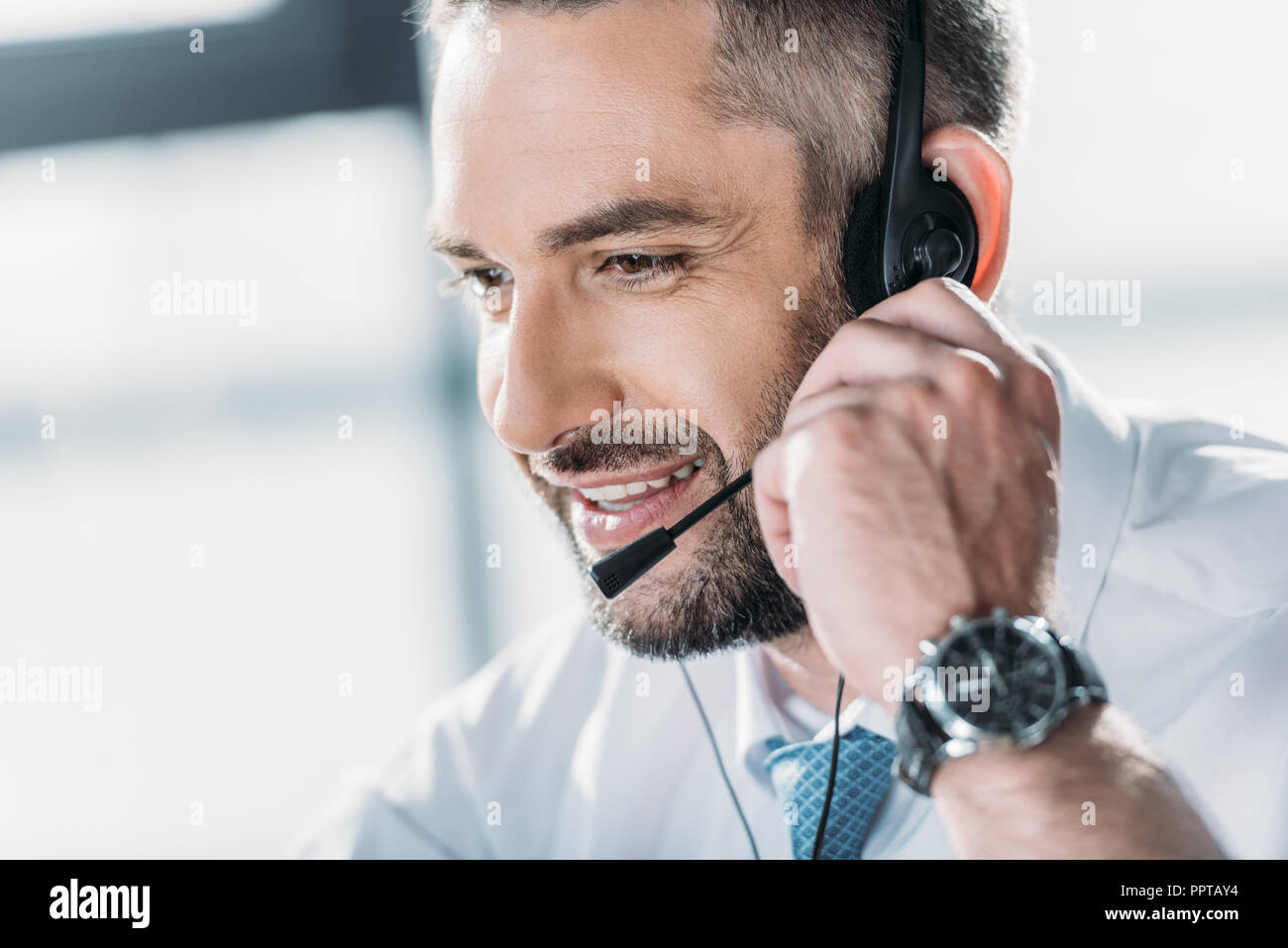 happy adult support hotline worker with microphone at work Stock Photo ...