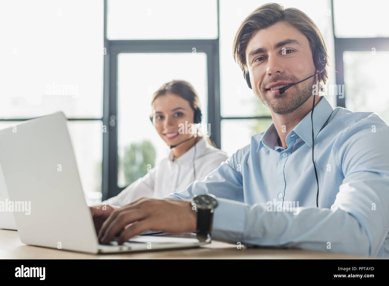 male and female call center managers working together at modern office ...