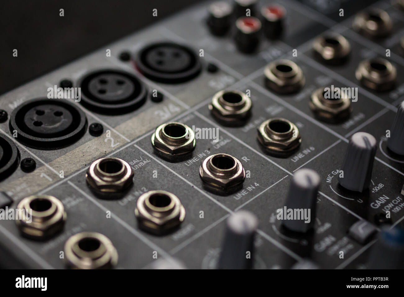 rows of silver gold audio input connectors, on a professional audio ...