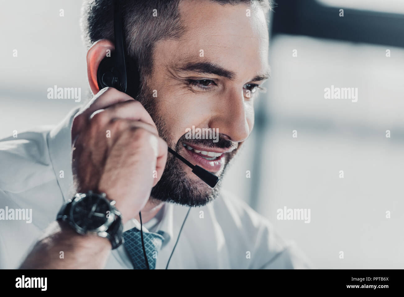 happy adult support hotline worker with microphone at work Stock Photo ...