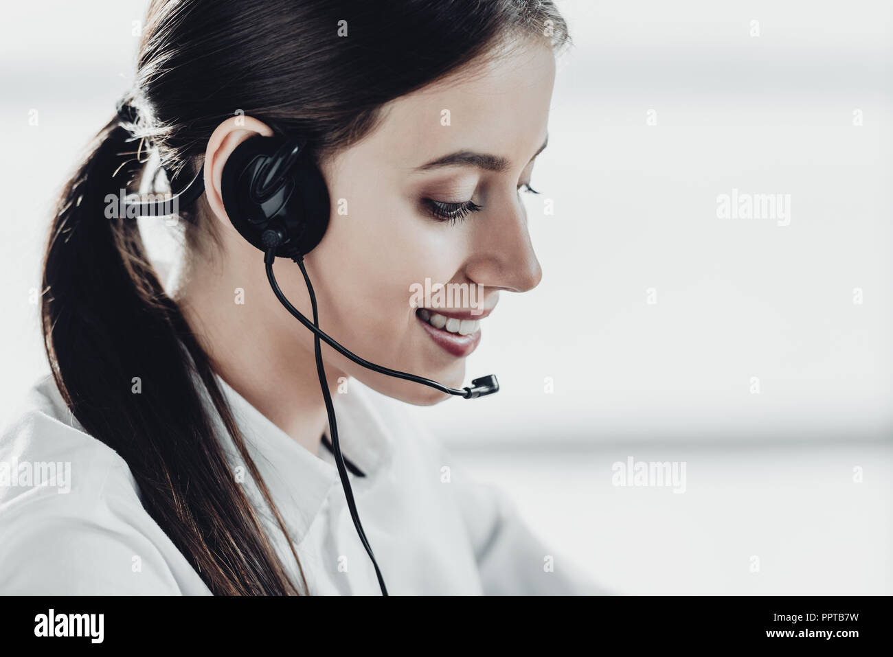 beautiful female call center worker with headphones Stock Photo - Alamy