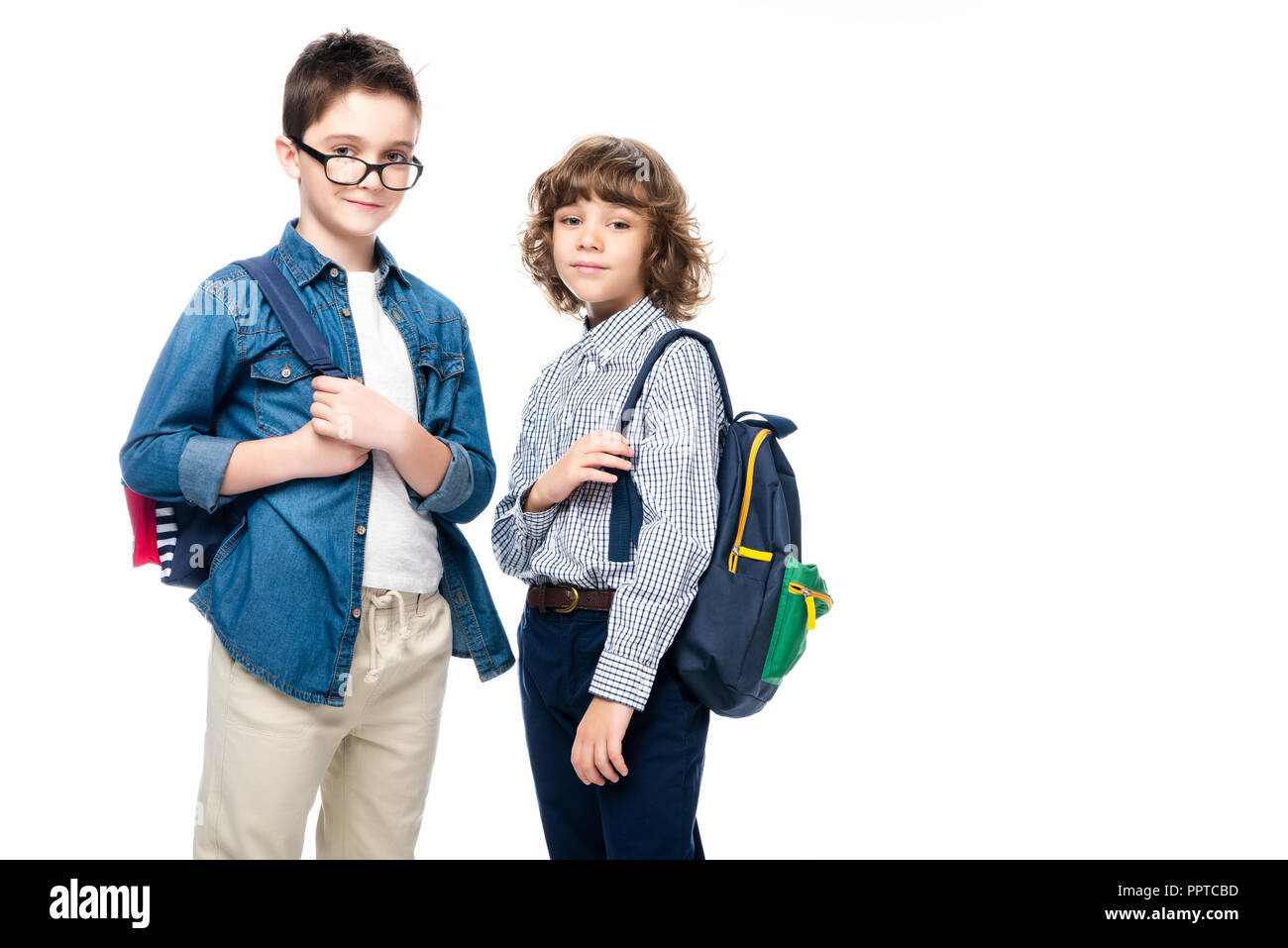 two schoolboys with backpacks looking at camera isolated on white Stock ...