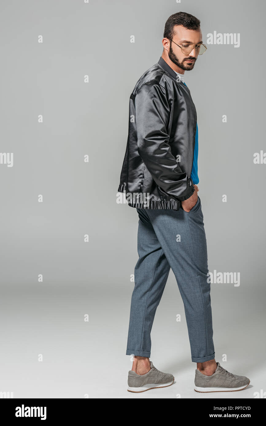 fashionable male model in autumn outfit posing on grey background Stock ...