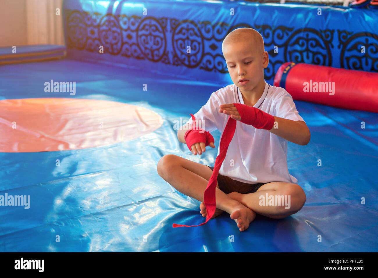 boy boxer in the gym wraps his hands with bandages Stock Photo - Alamy